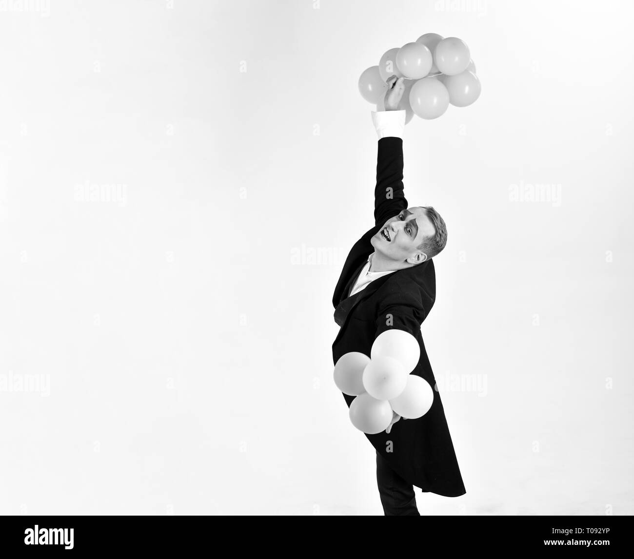 Happy birthday or anniversary celebration. Mime man with party balloons ...