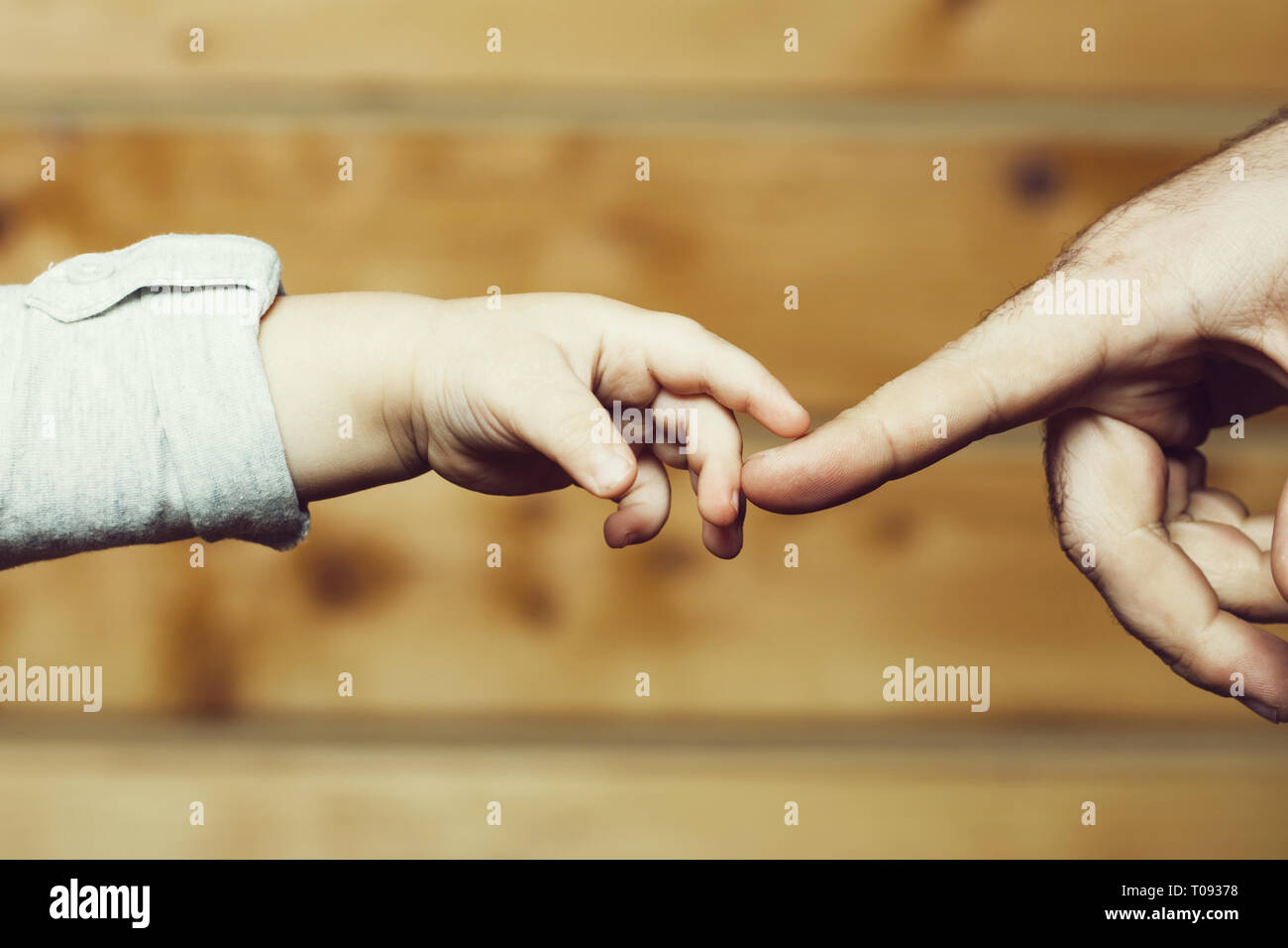Hands of son and father Stock Photo - Alamy