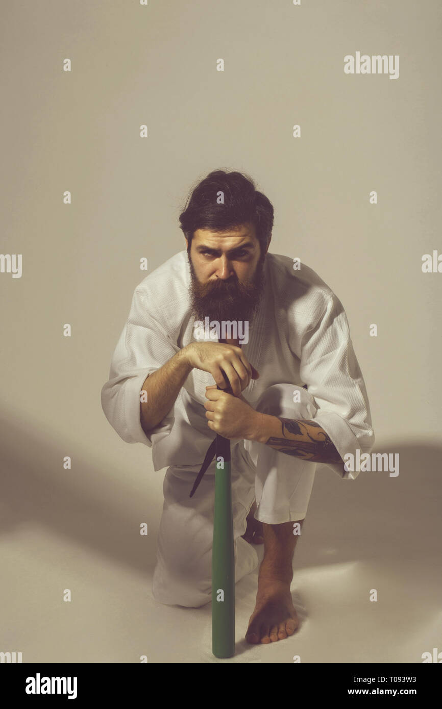bearded serious karate man in kimono with green baseball bat Stock ...
