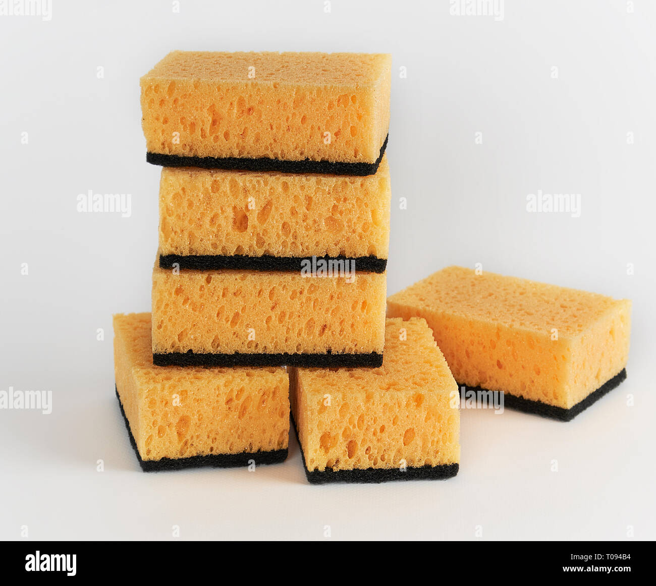 stack of yellow kitchen sponges for washing dishes on a white ...