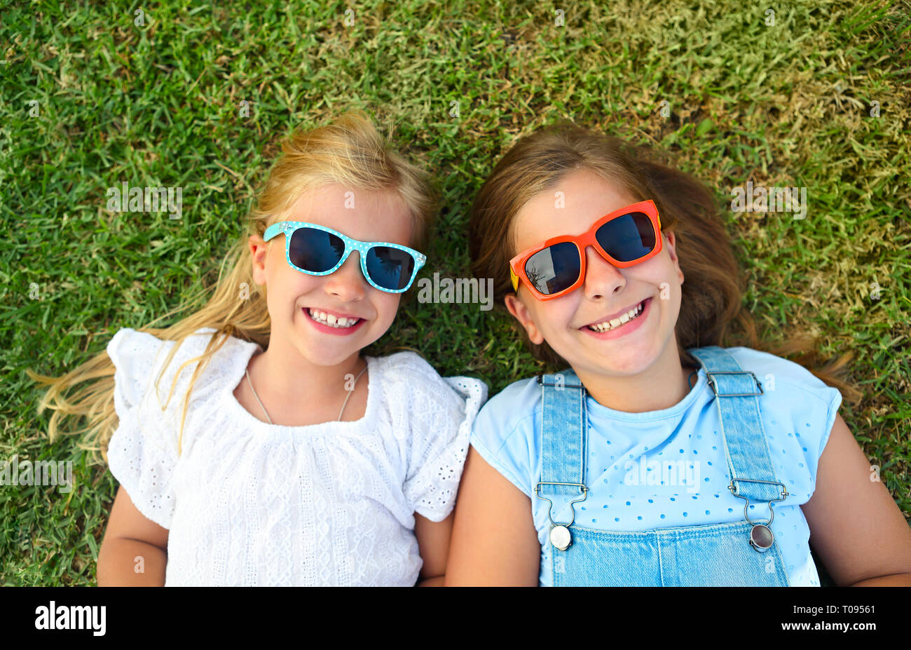Laughing children wearing sunglasses relaxing during summer day on the ...