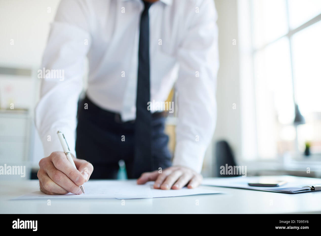 Man putting signature on hi-res stock photography and images - Alamy