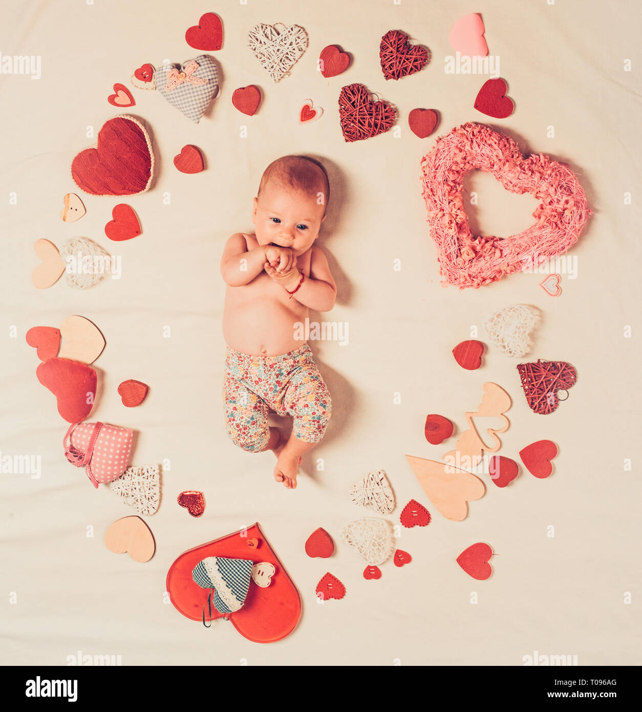 Live in love. Family. Child care. Small girl among red hearts. Sweet ...