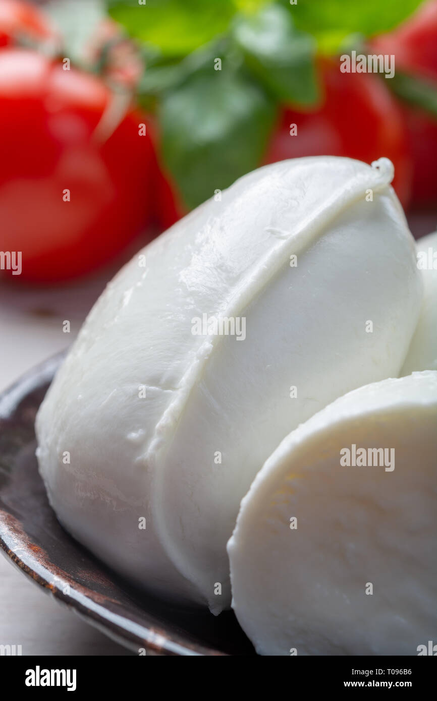 Balls and pieces of buffalo mozzarella, soft Italian scheese made from ...