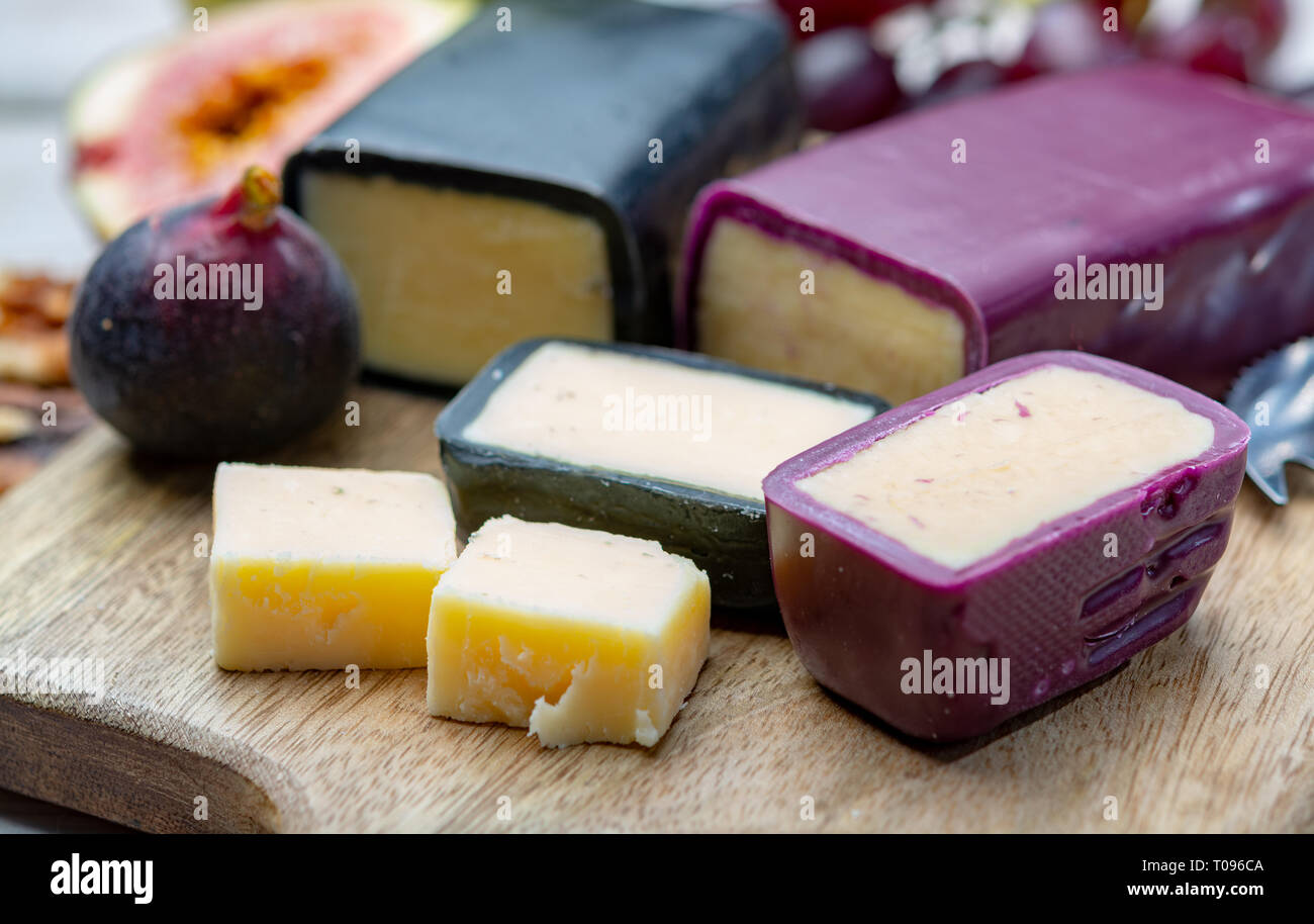Mini black and dark red waxed cheddar cheeses made from West Country ...