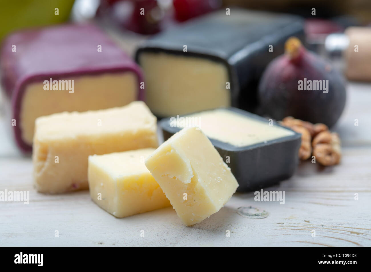 Mini black and dark red waxed cheddar cheeses made from West Country ...