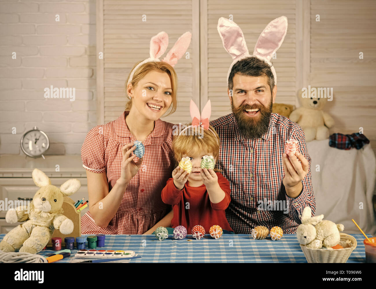 father and mother with son preparing eggs for Easter Stock Photo - Alamy