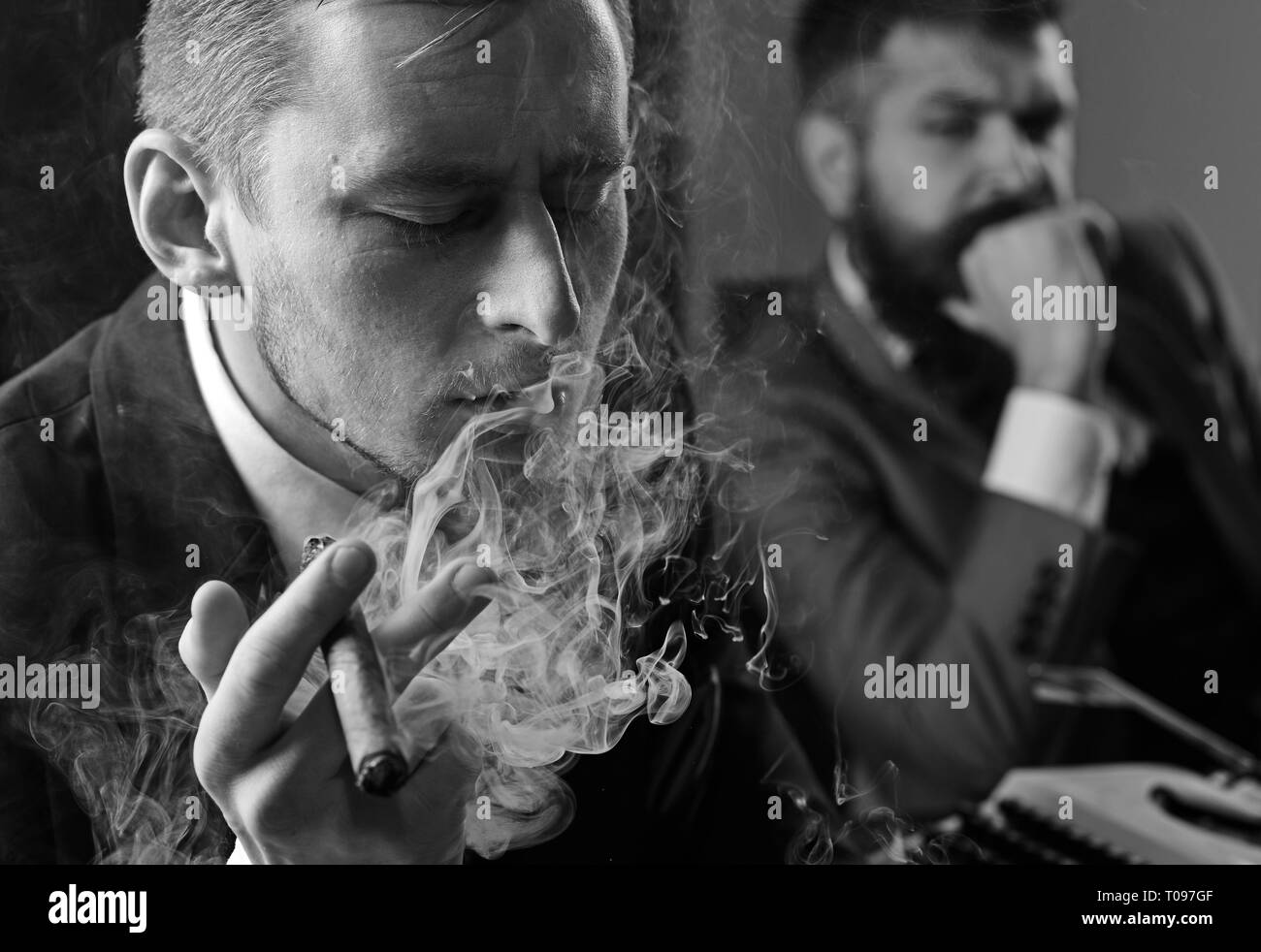 Thinking about problem solution. Thoughtful man smoking cigar ...