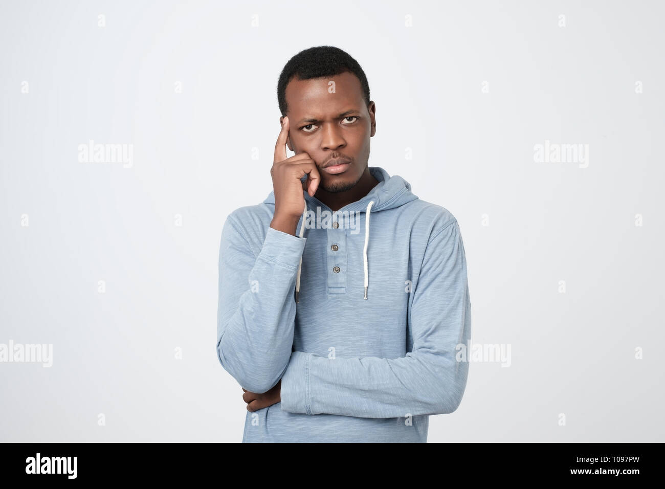Studio portrait questionable looking young hi-res stock photography and ...