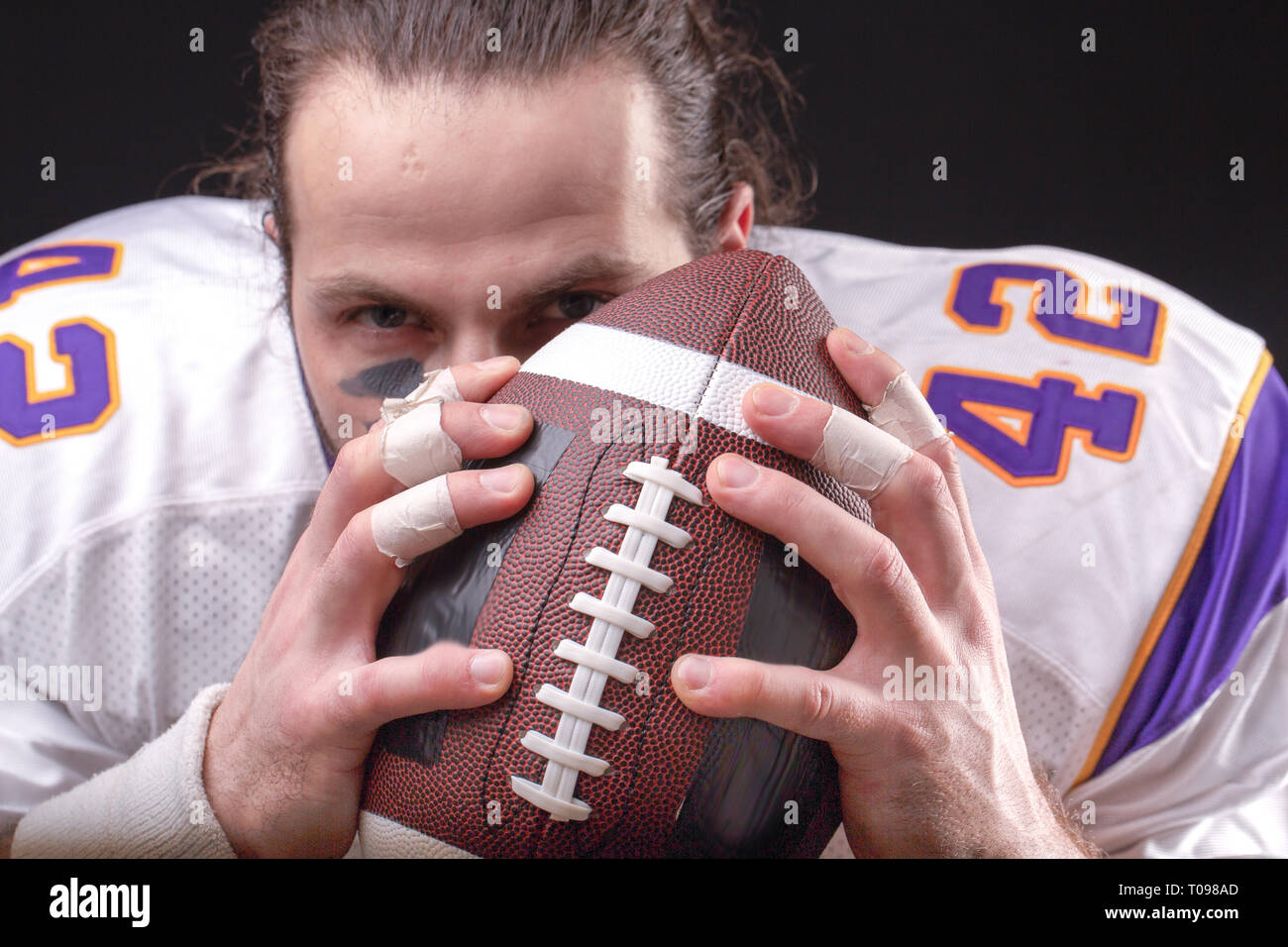 Ball for American football in front of footballer face Stock Photo - Alamy