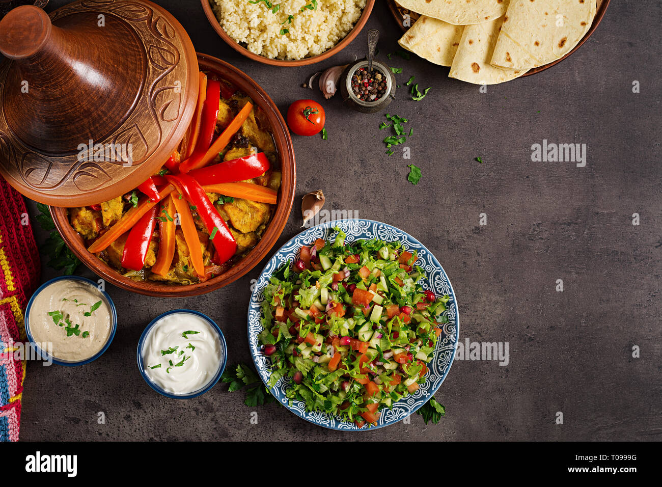 Moroccan food. Traditional tajine dishes, couscous and fresh salad on ...