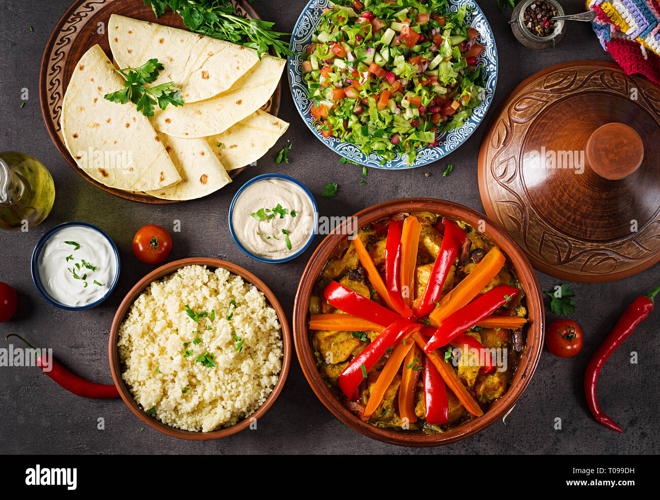 Moroccan food. Traditional tajine dishes, couscous and fresh salad on ...