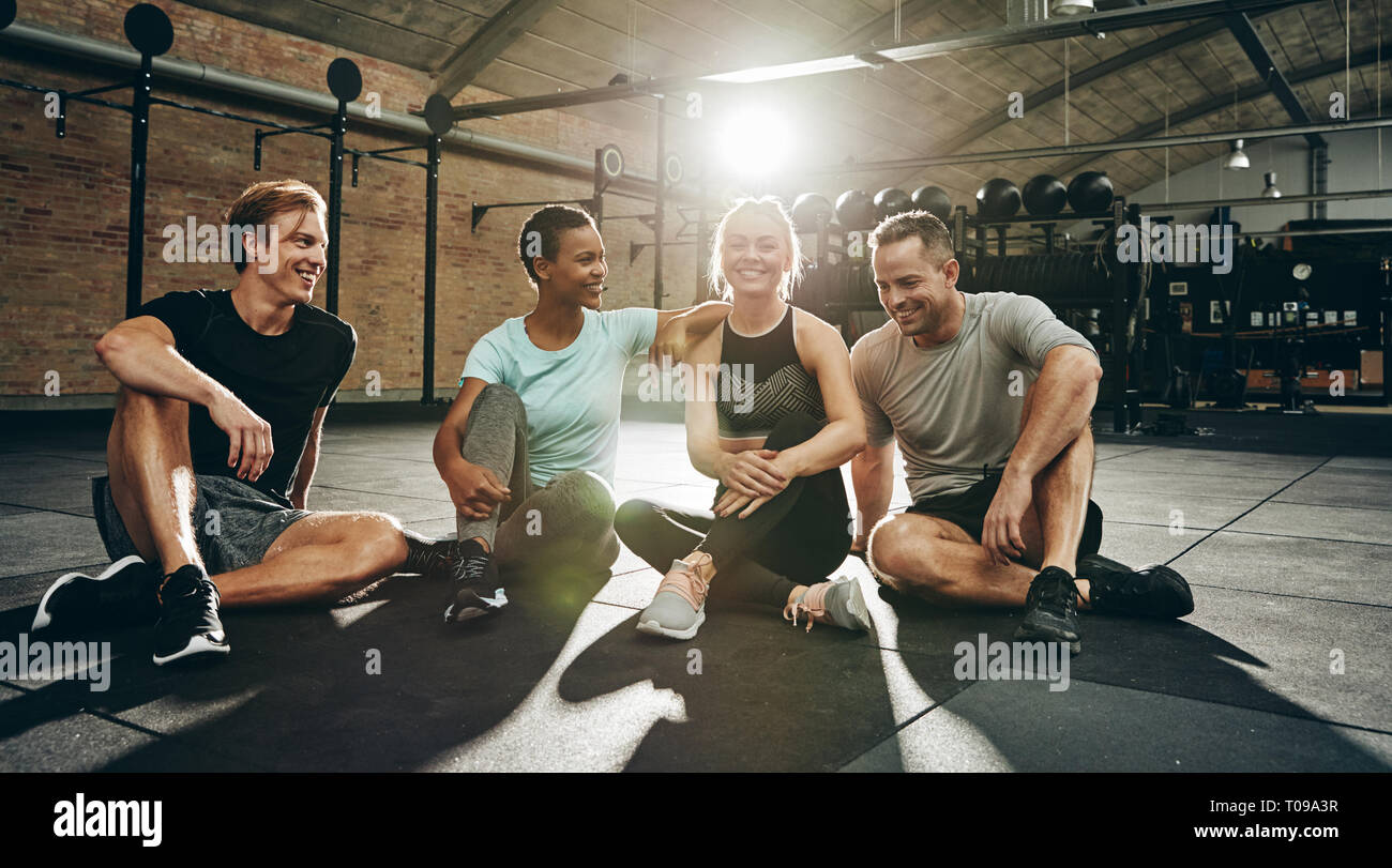 Young men in gym talking and resting hi-res stock photography and ...