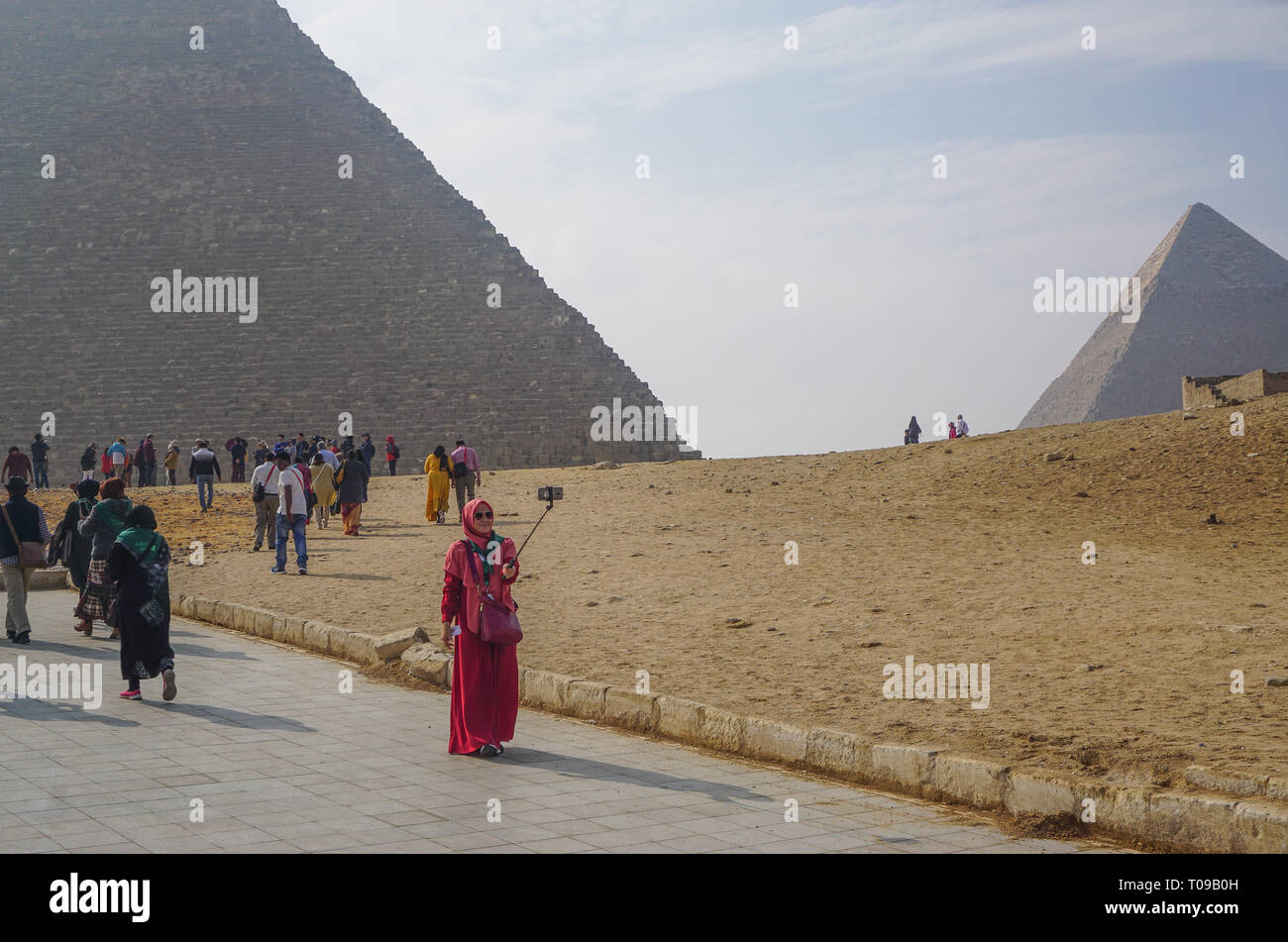 Giza, Egypt: A woman wearing a hijab taking a selfie at the Khufu ...