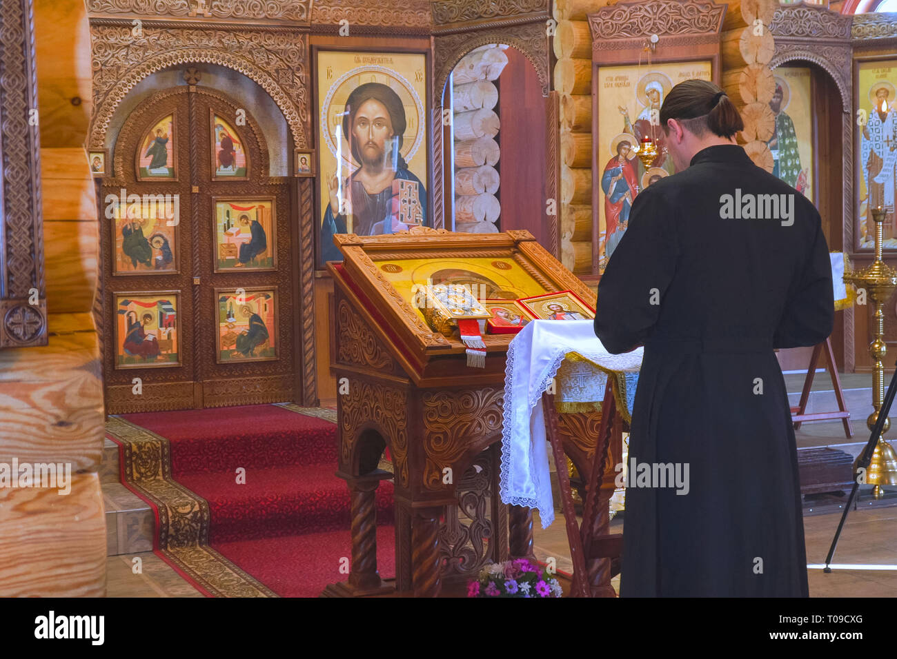 The priest is behind the lectern Stock Photo - Alamy