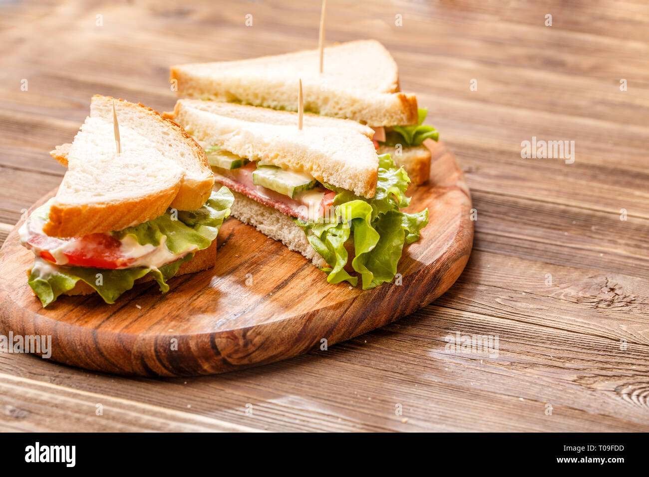 Burgers with toothpicks and vegetables Stock Photo - Alamy
