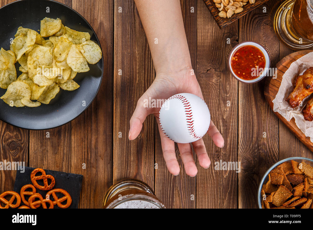 Table with hands with baseball Stock Photo - Alamy