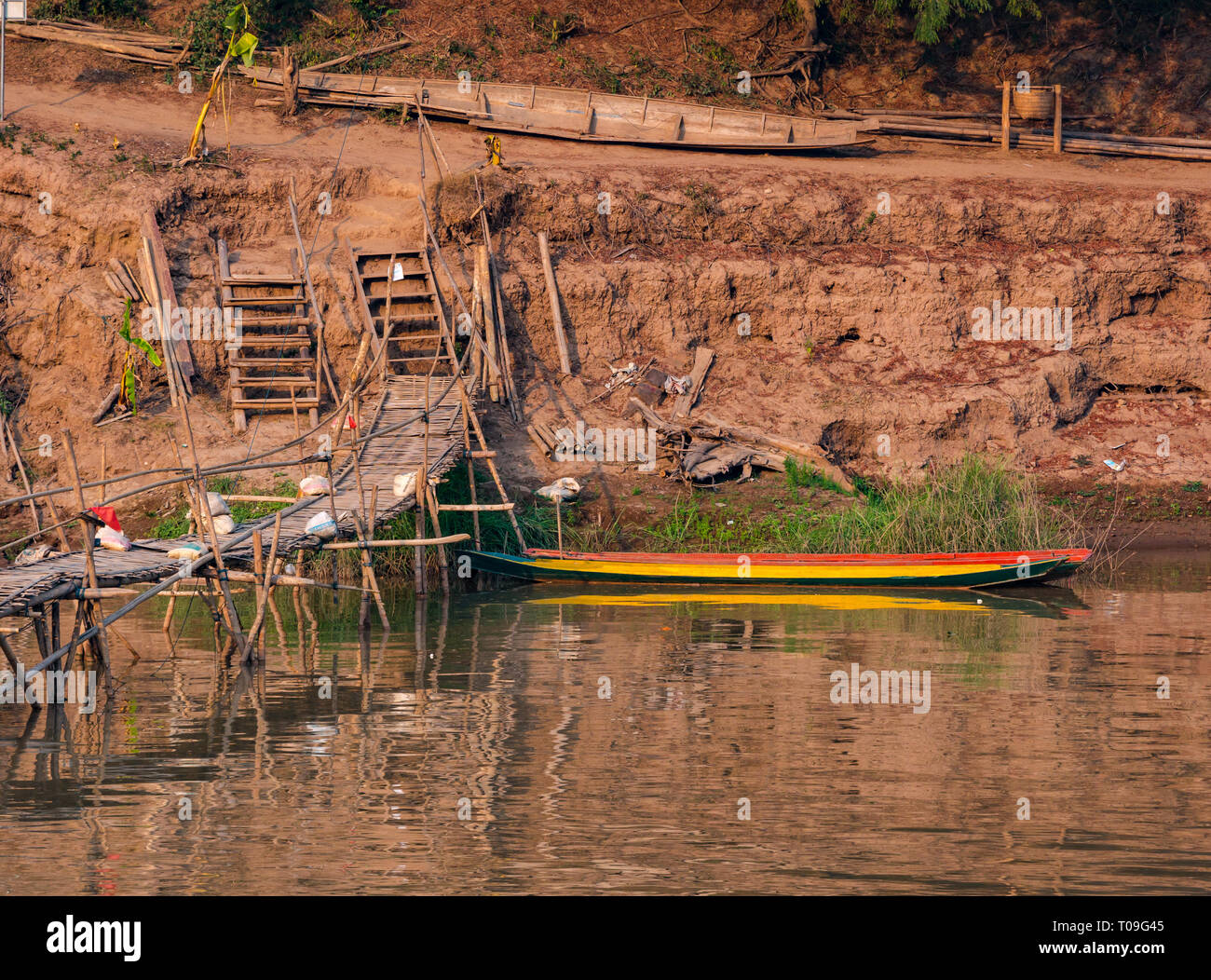 Bamboo cane bridge over Nam Kahn river tributary of Mekong with ...