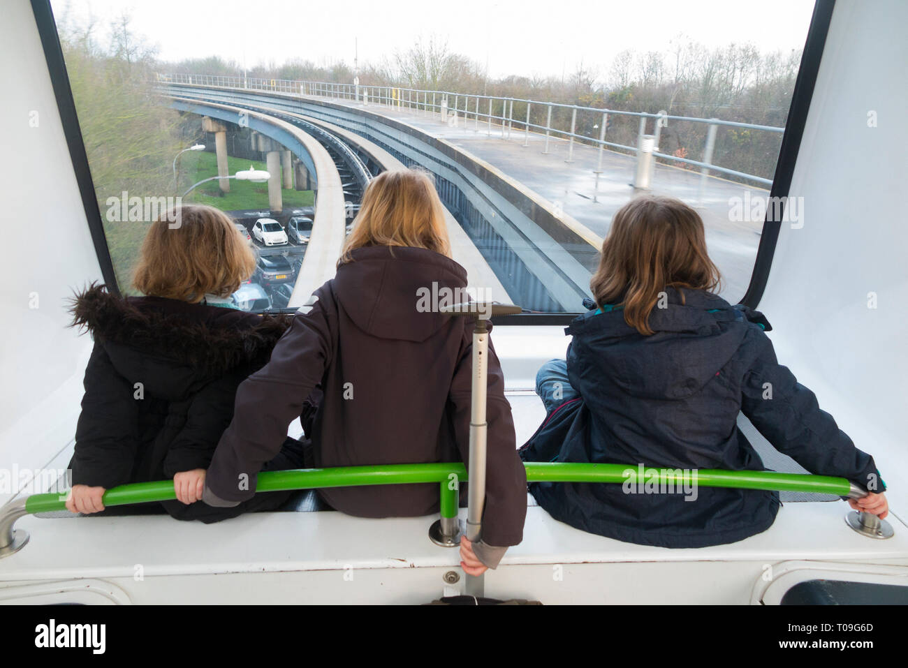 Three sisters, girls, children, kids, ride the inter-terminal shuttle ...