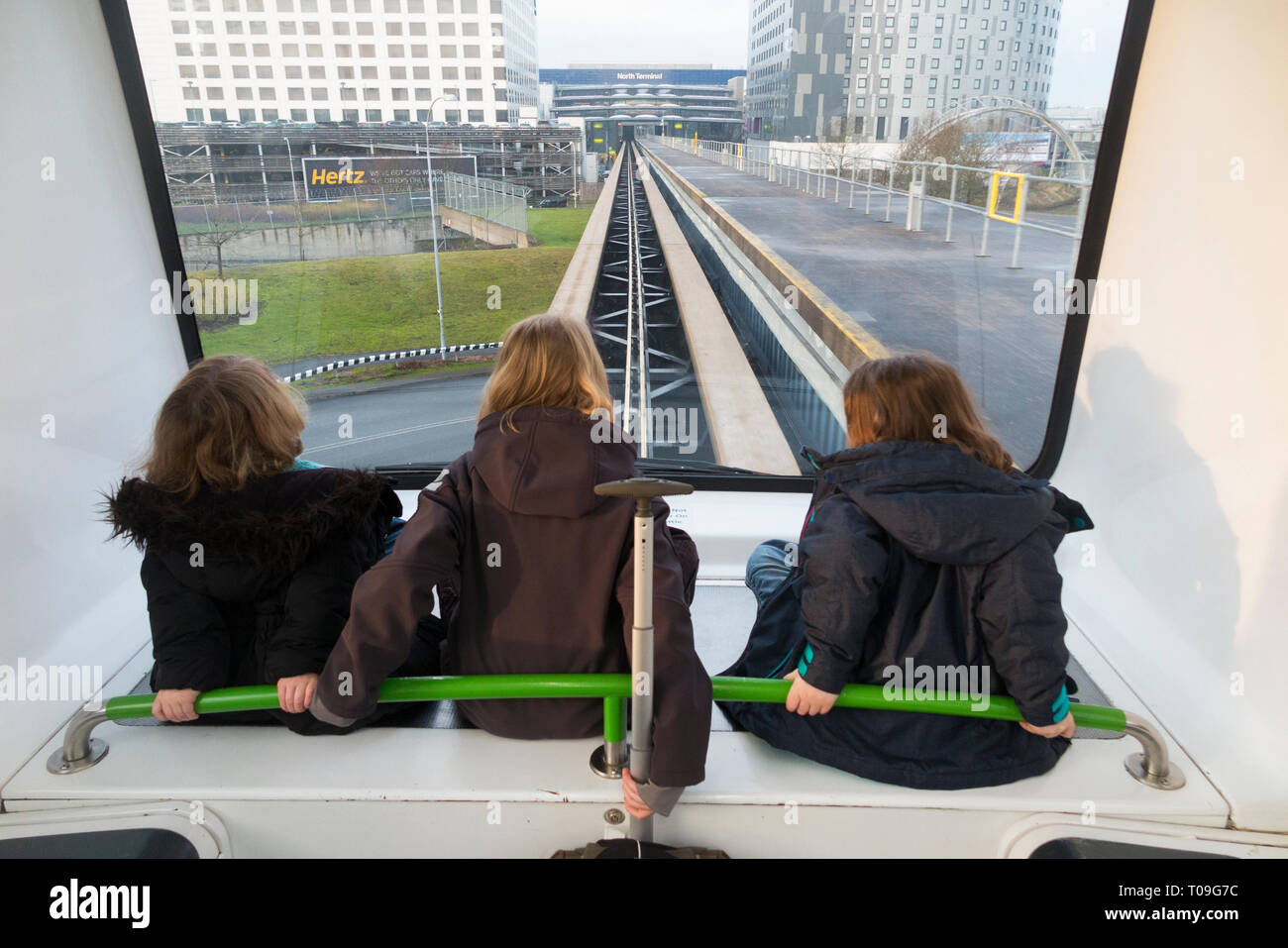 Three sisters, girls, children, kids, ride the inter-terminal shuttle ...