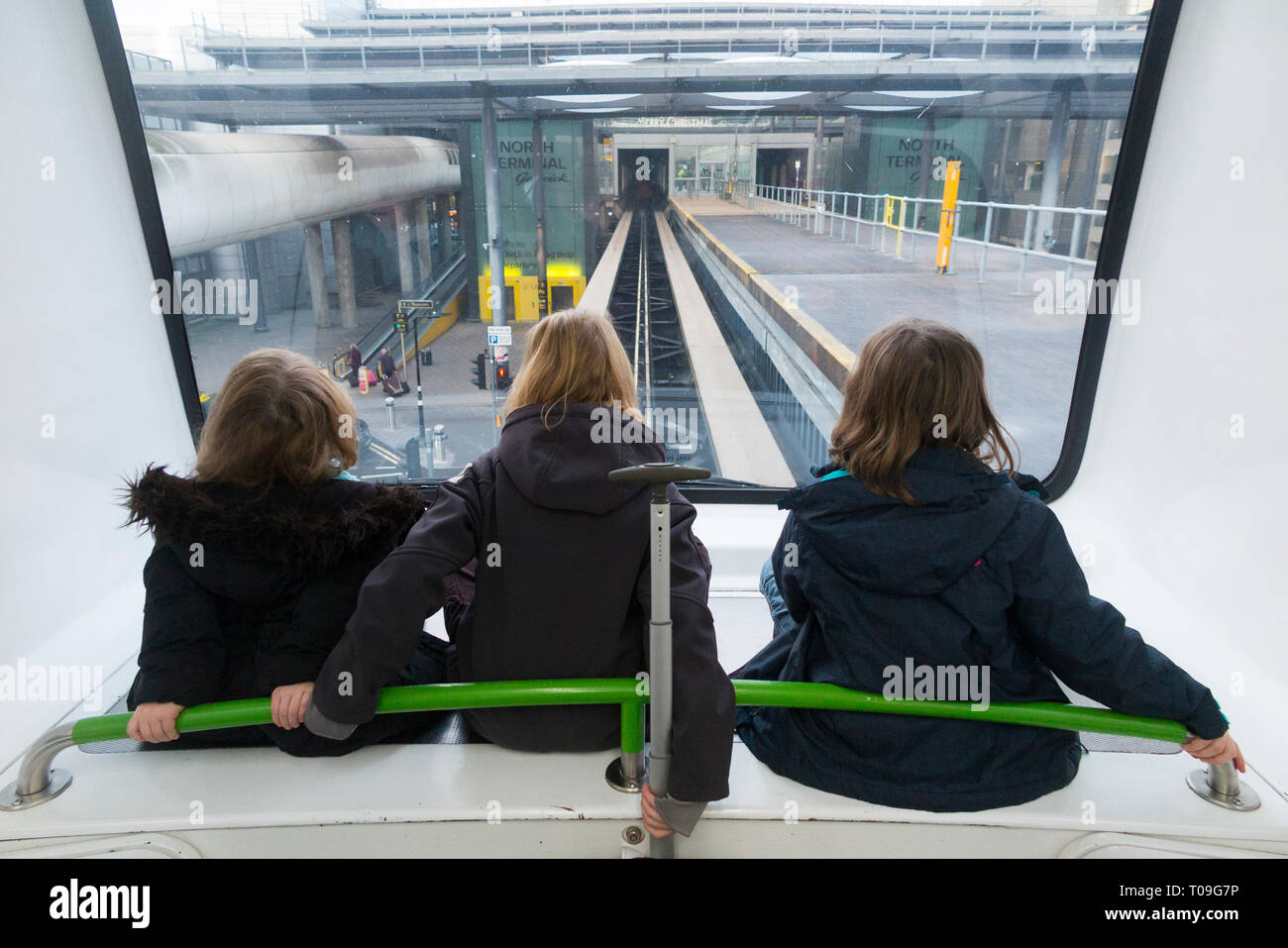 Three sisters, girls, children, kids, ride the inter-terminal shuttle ...