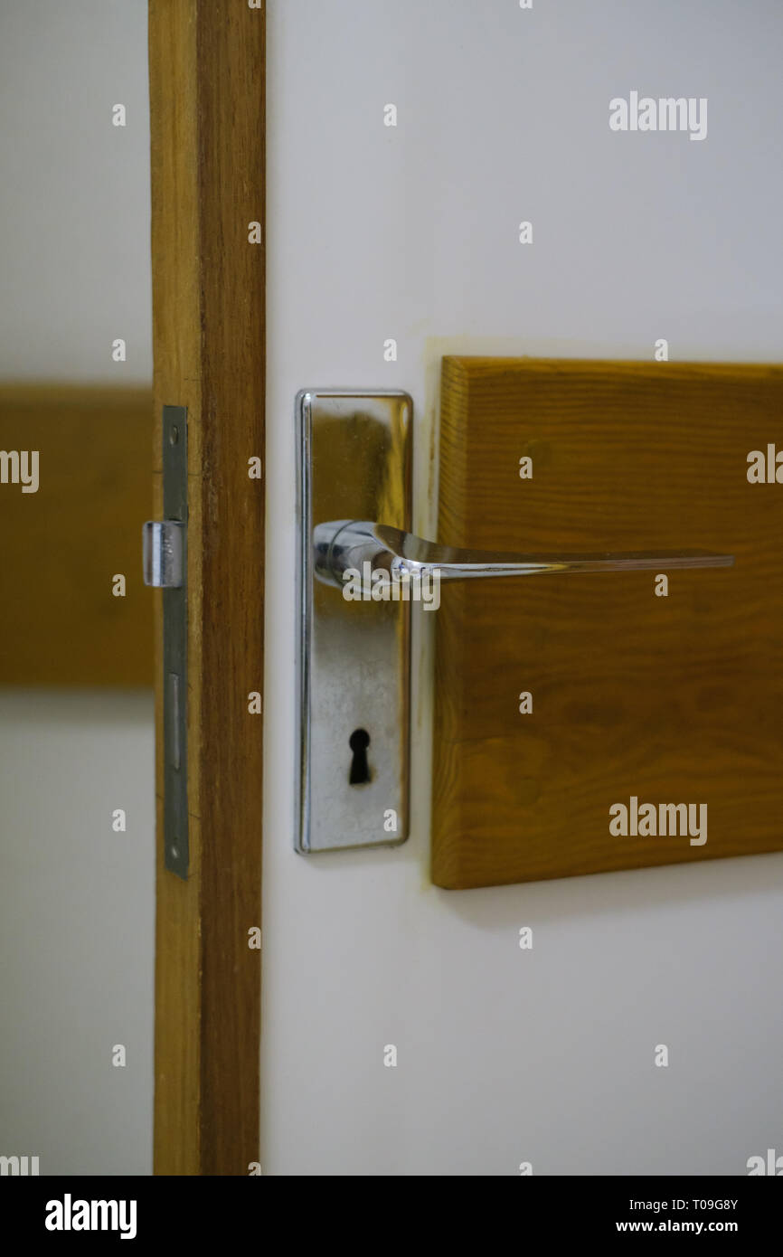 Old door with a metal hand bar Stock Photo - Alamy