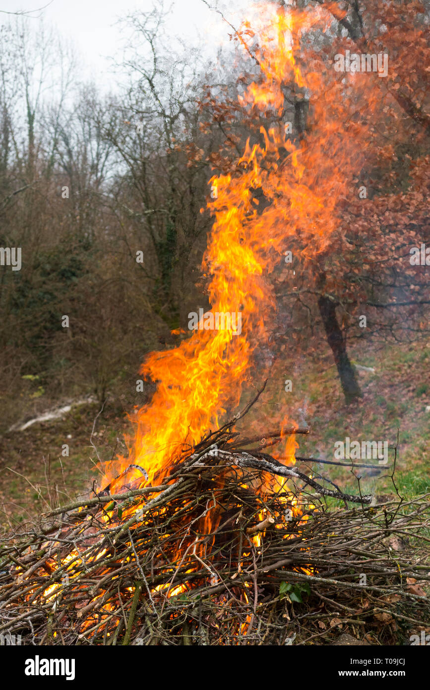 Garden fire with fierce flames with smoke fumes rising from a bonfire ...