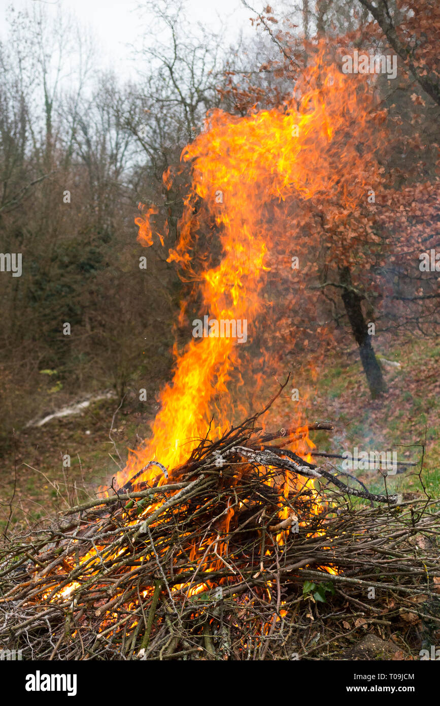 Garden fire with fierce flames with smoke fumes rising from a bonfire ...