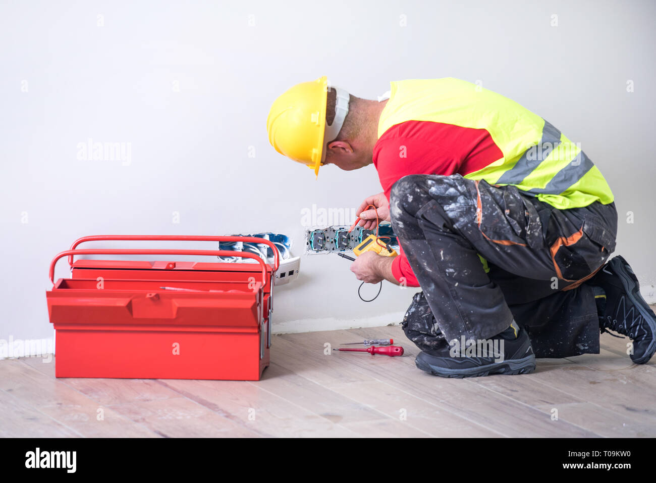 Electrician repairing / fixing wires in the wall Stock Photo - Alamy