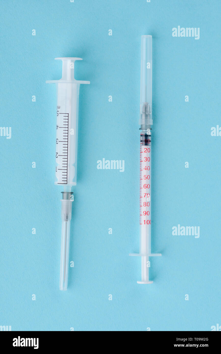 Two syringes on blue background. Making injections using medical ...