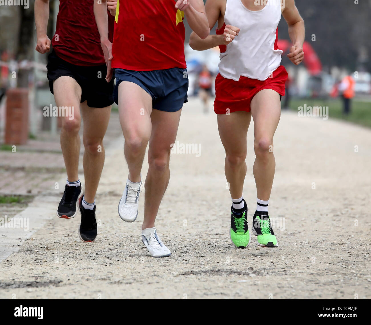 Three runners at finish line after the cross country footrace Stock ...