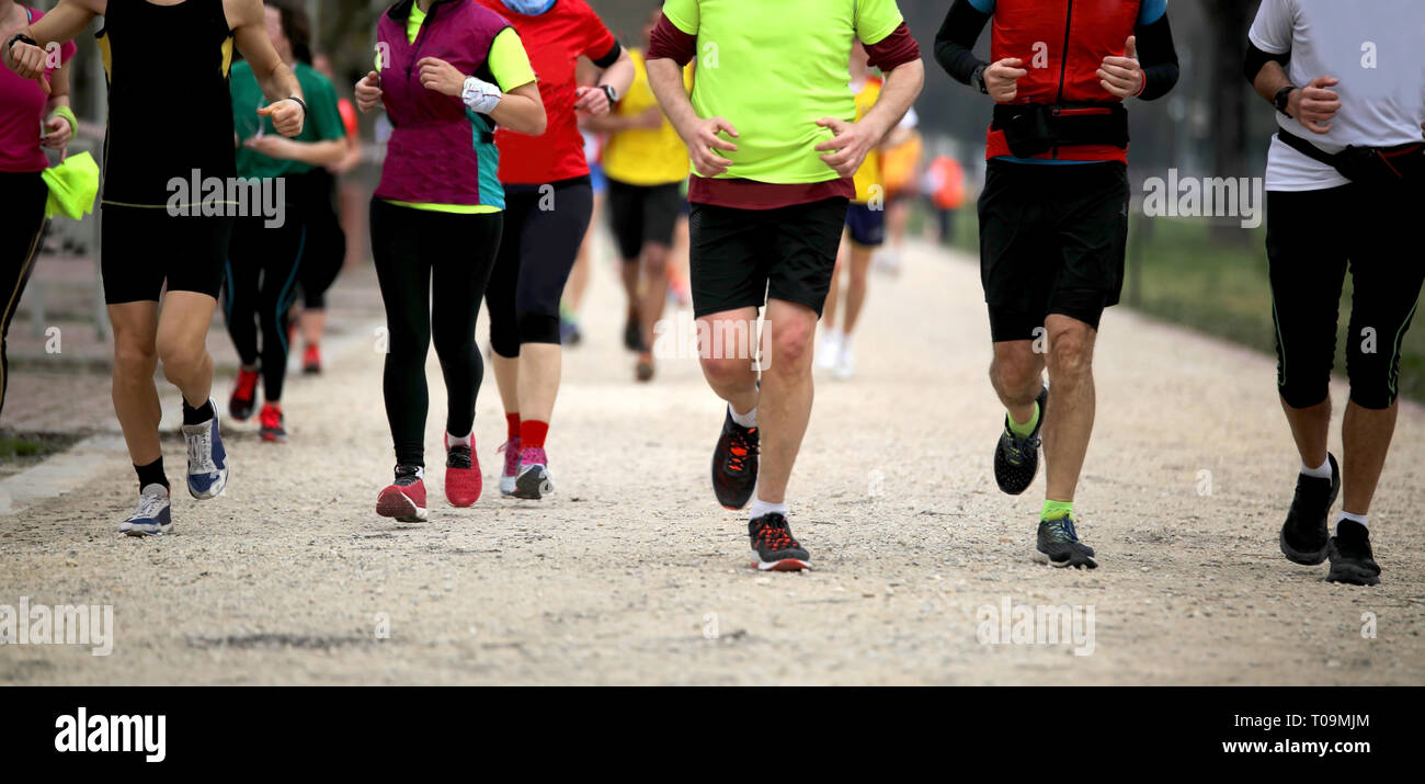 many runners at finish line after the footrace Stock Photo - Alamy