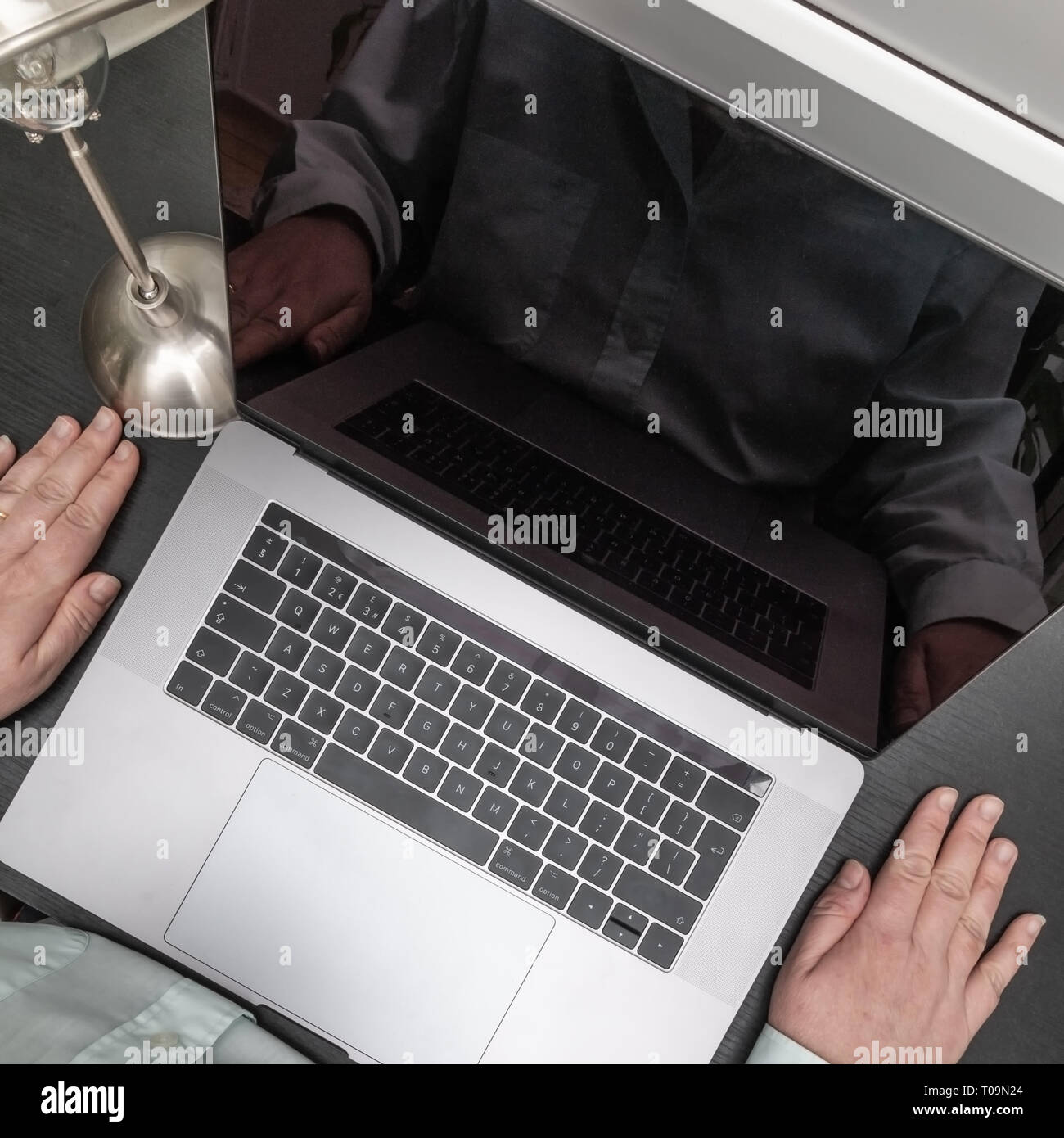 conceptual shot of a laptop computer with a blank screen and two hands ...