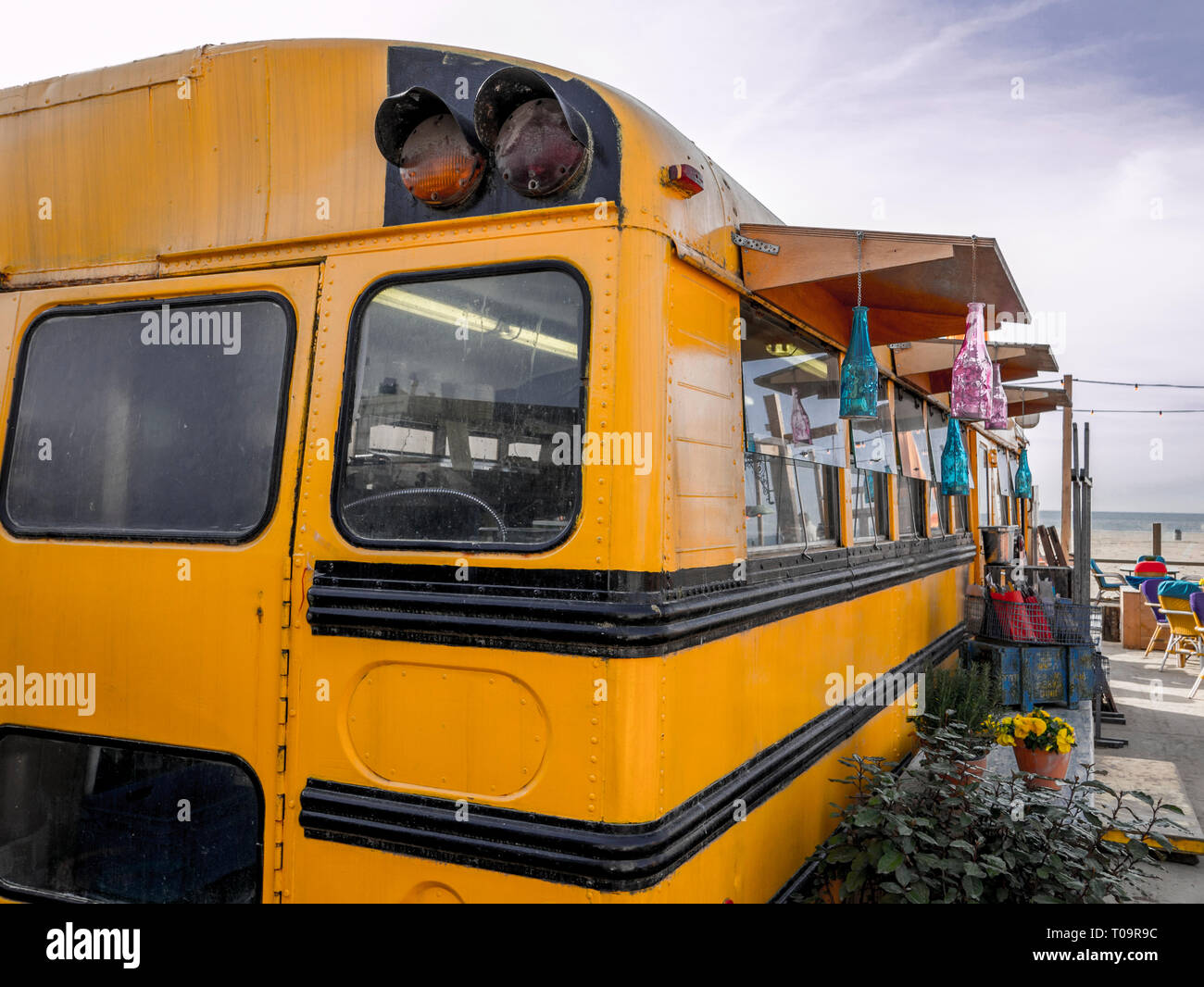old american schoolbus turned into beach bar Stock Photo - Alamy