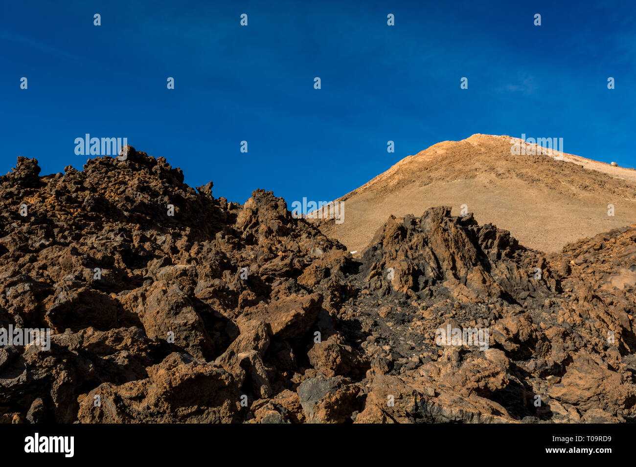 Majestic volcanic cone rising above spectacular lava shaped landscape ...