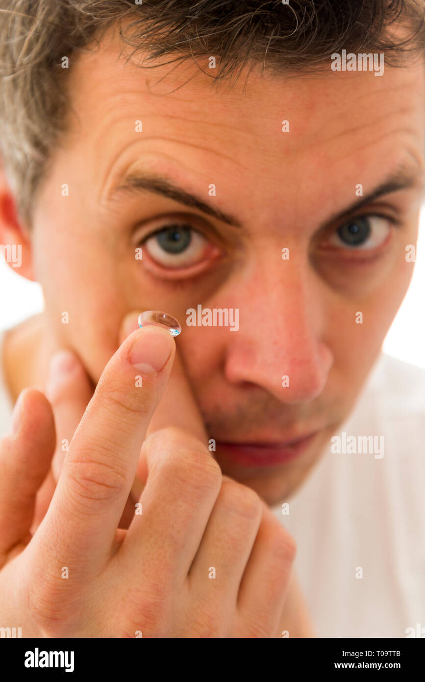 man with contact lens on finger, ready to place it on his eye Stock ...