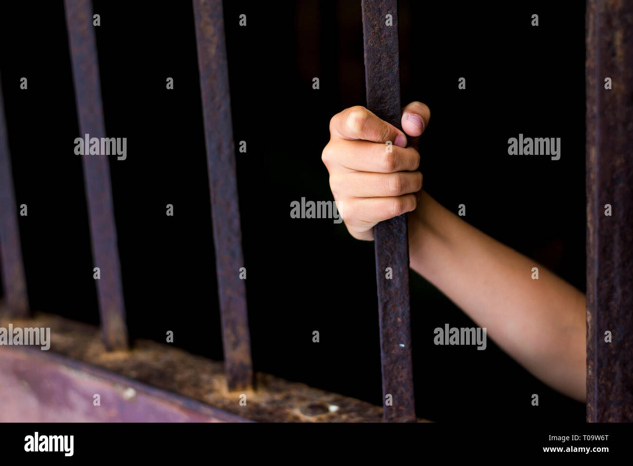 Hand holding prison bars hi-res stock photography and images - Alamy