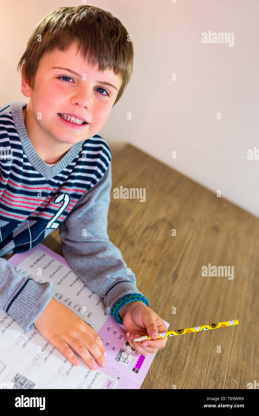 kid making his homework, with a smile Stock Photo - Alamy