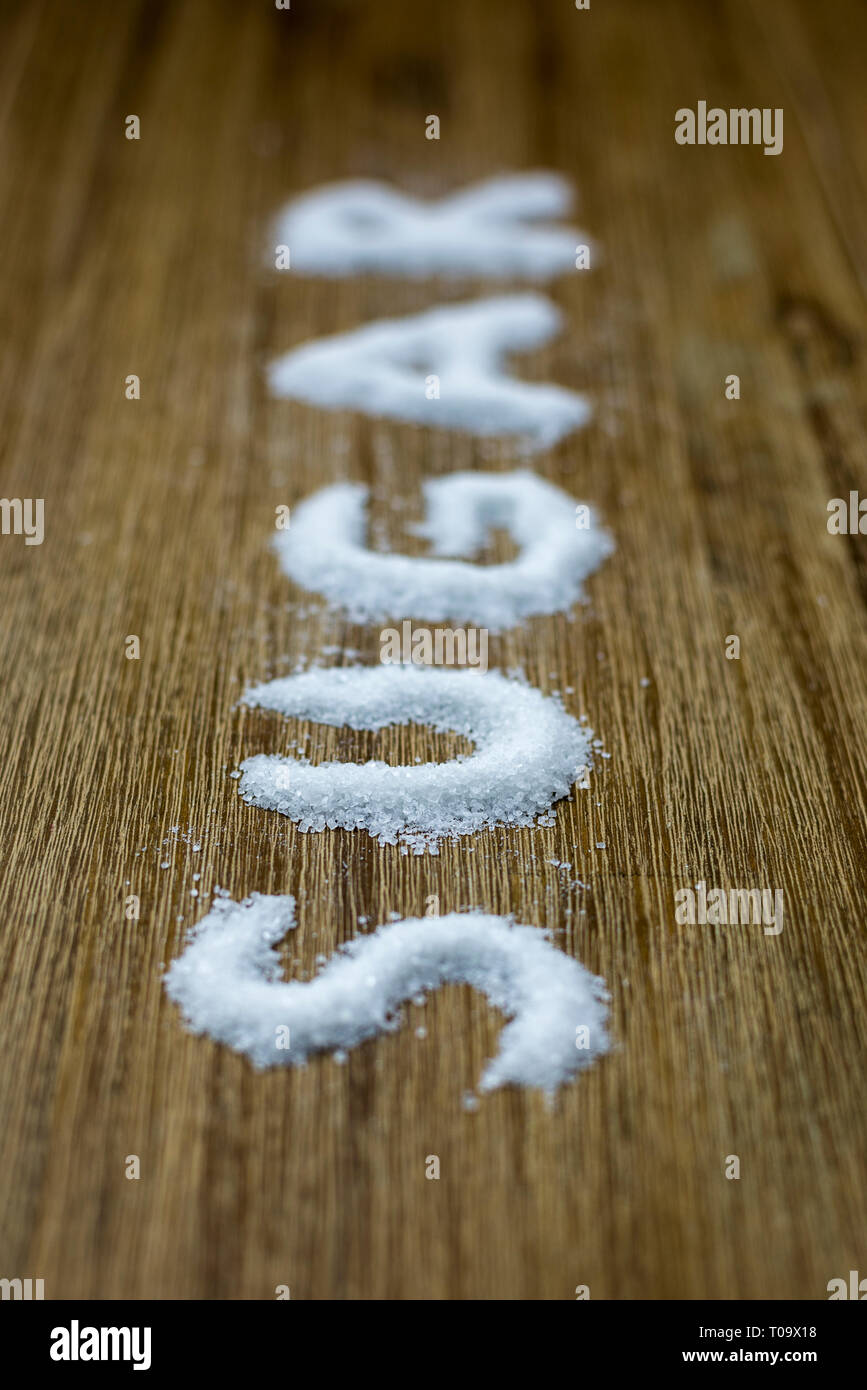 sugar text written with sugar crystals on table Stock Photo - Alamy