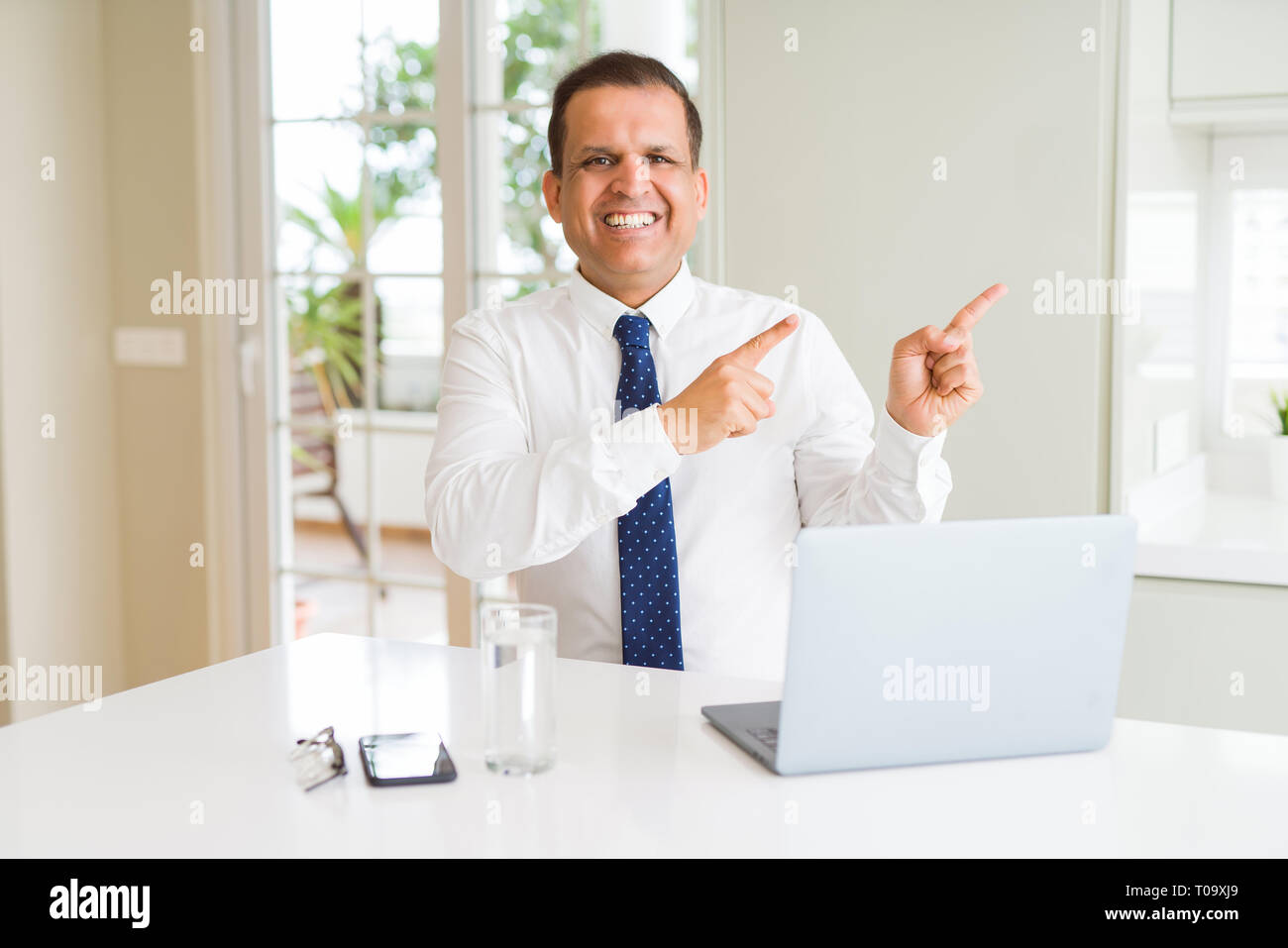 Middle age business man working with computer laptop smiling and ...