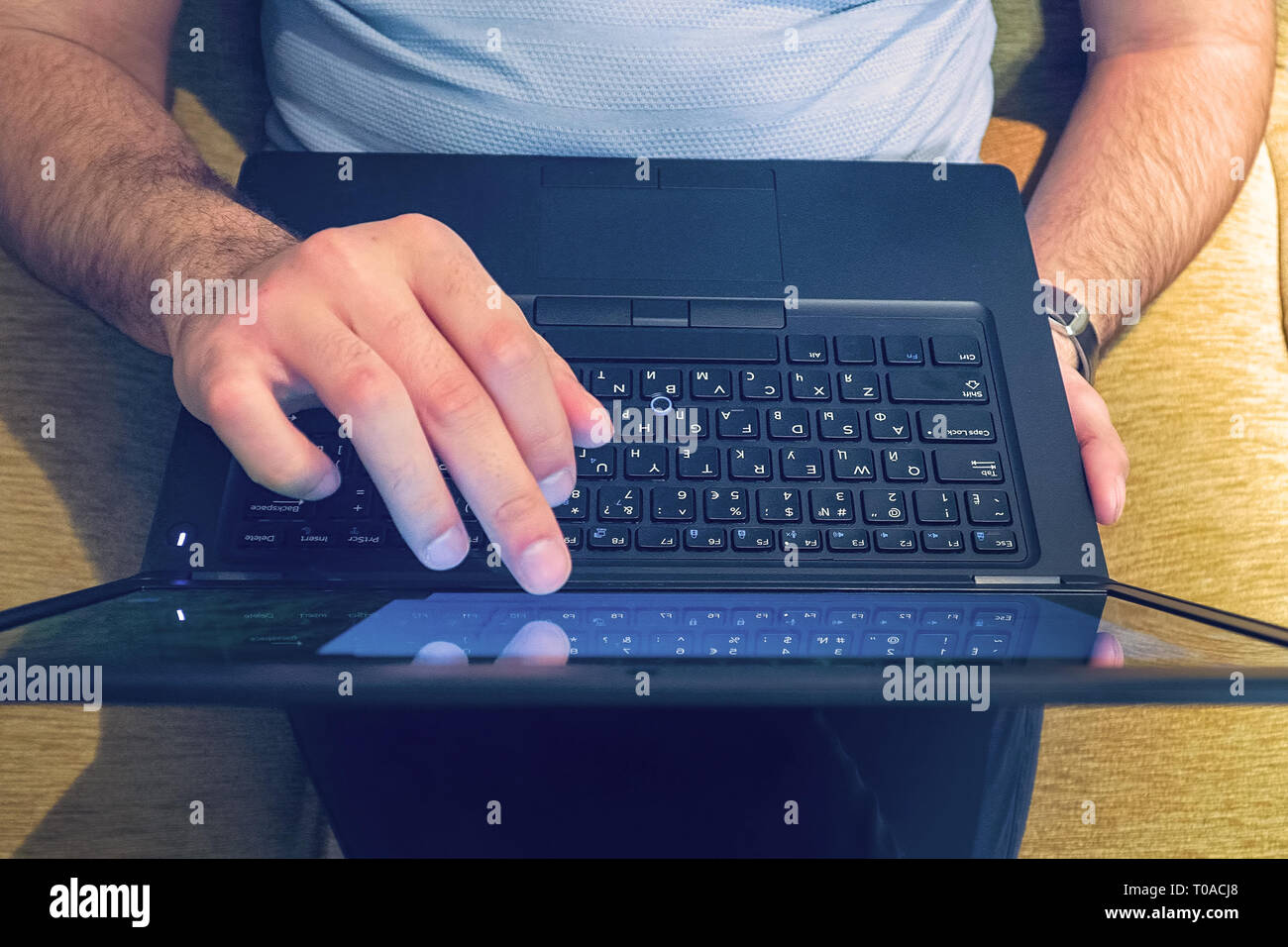 Man works with a laptop touching the screen with his fingers Stock ...
