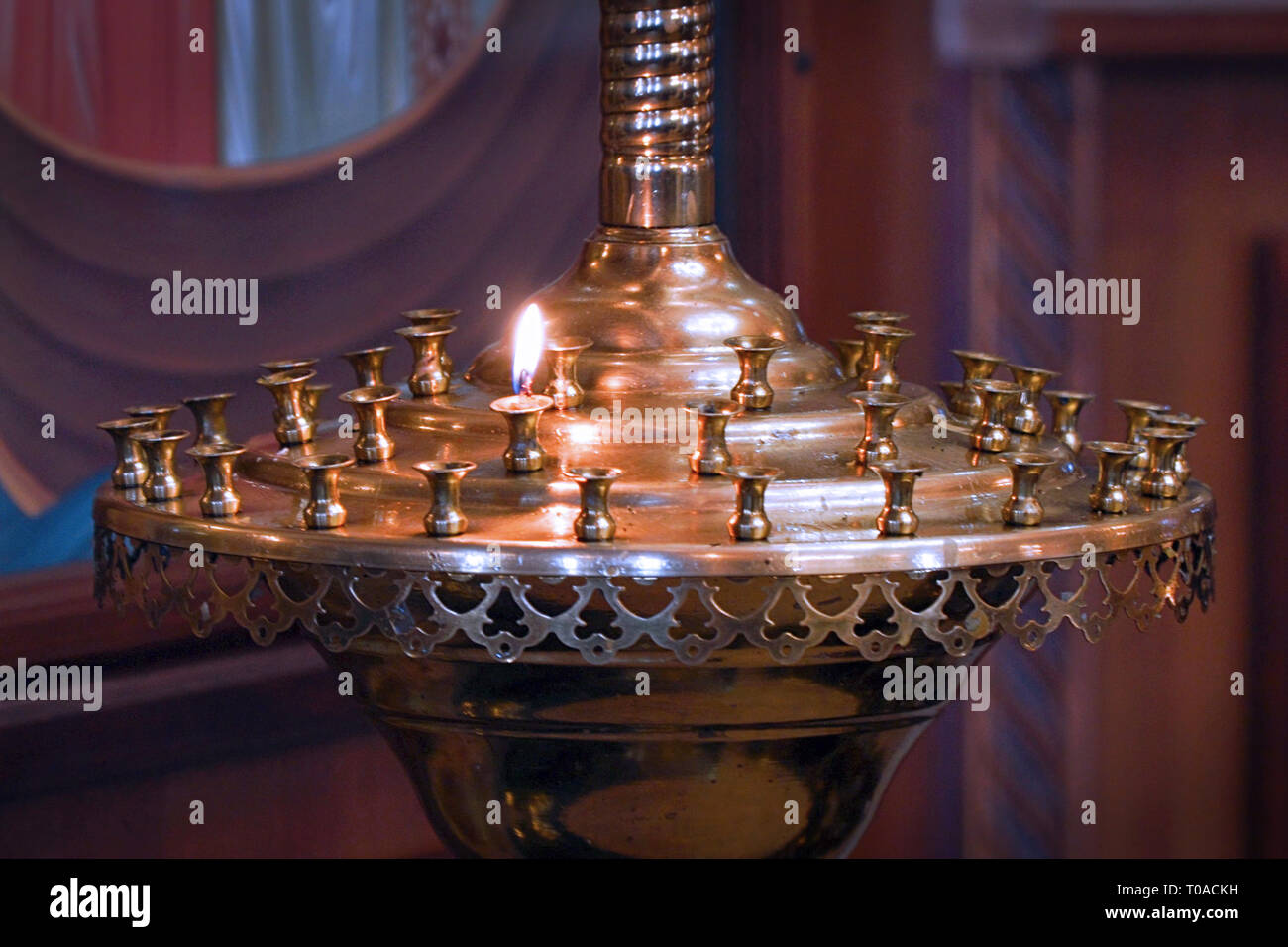 Small candle in a Church candlestick Stock Photo - Alamy