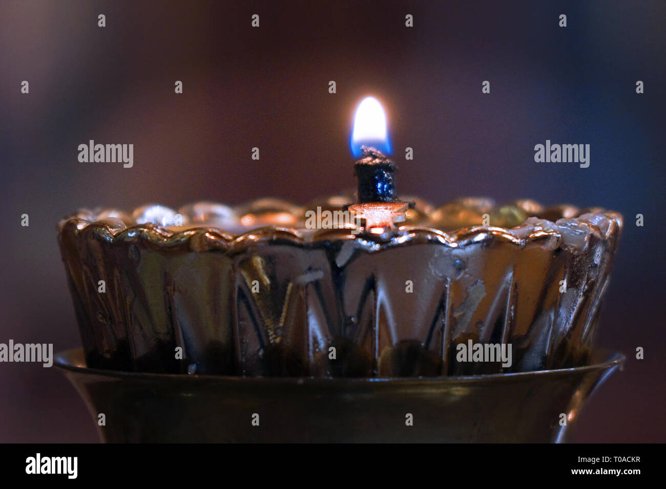 Small candle in a Church candlestick Stock Photo - Alamy