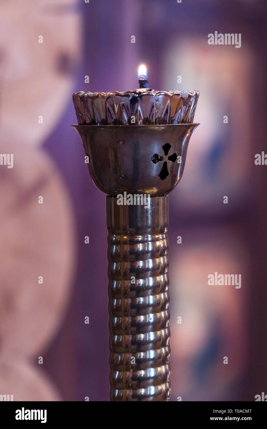 Small candle in a Church candlestick Stock Photo - Alamy