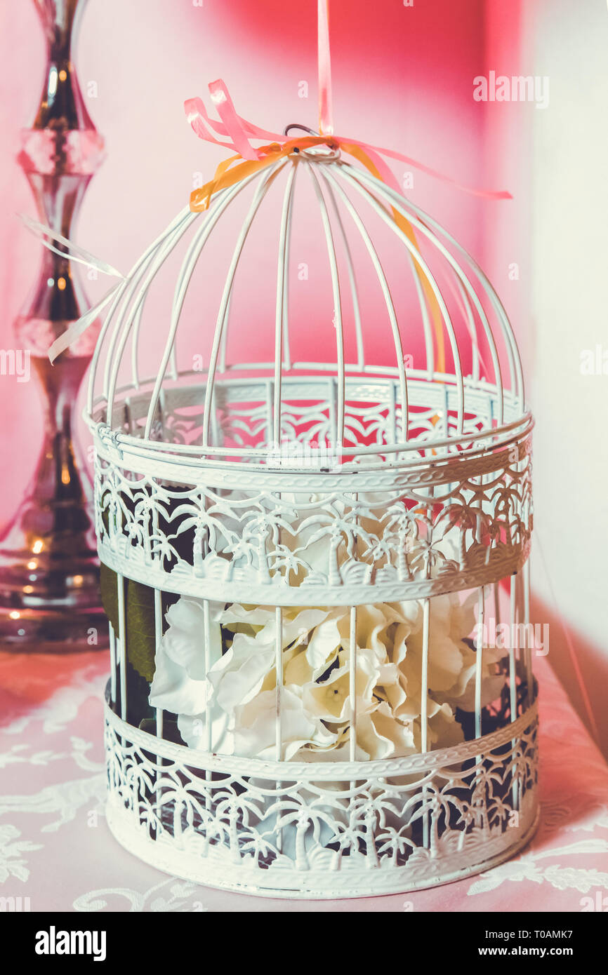 Candy Bar. The cage with flowers stand in restaurant . white roses put ...