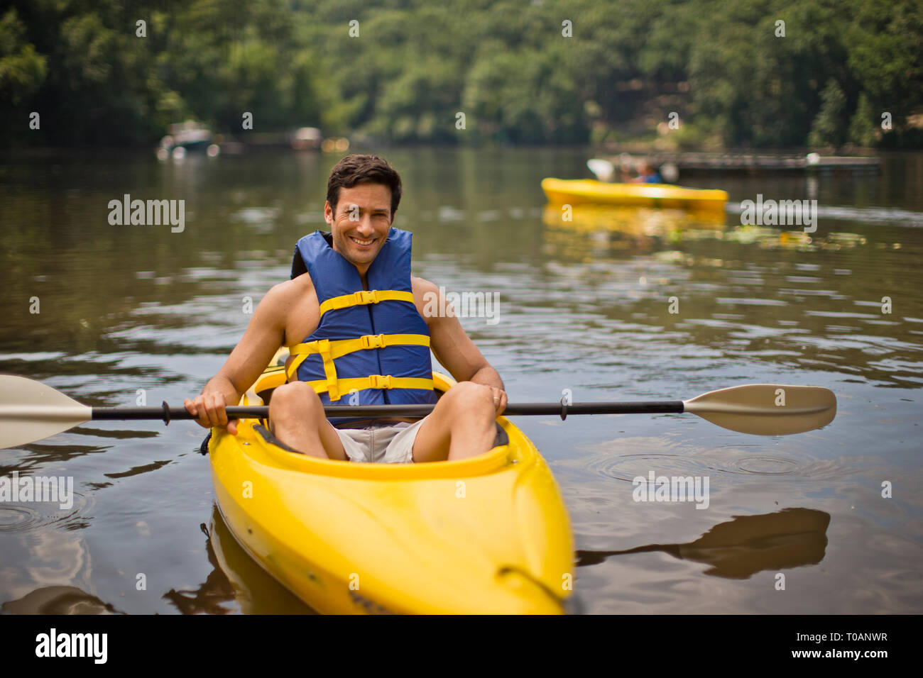 Portrait of a smiling man sitting in kayak Stock Photo - Alamy
