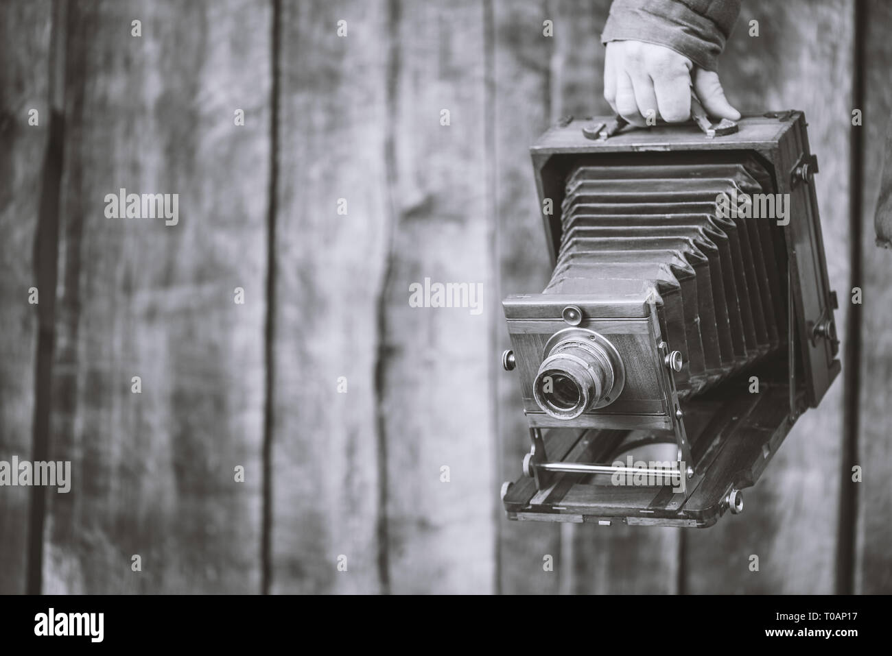 Large format retro camera, 5x7 inches. Photographer holds in hand old ...