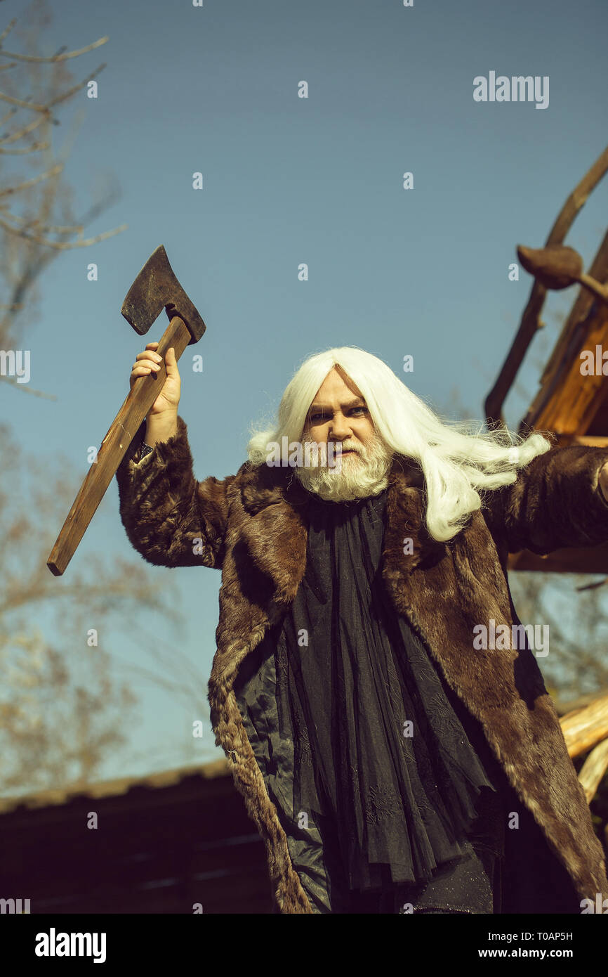 Brutal old druid with axe Stock Photo - Alamy