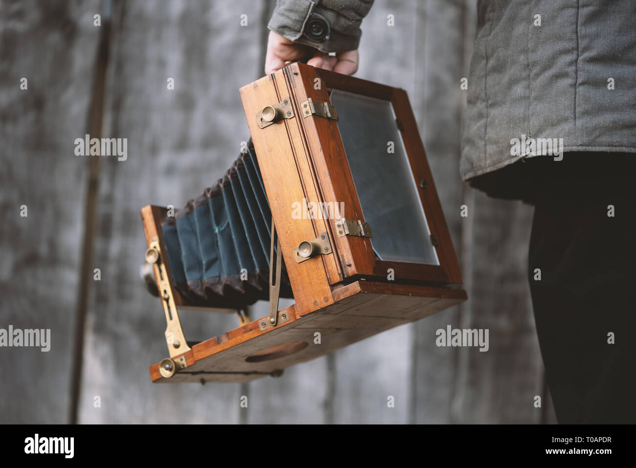 Photographer holds vintage large format studio camera, 5x7 inches ...