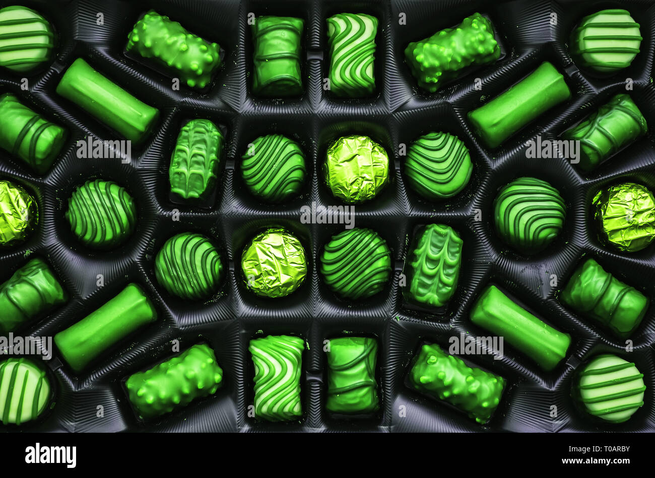 Green chocolate candies in the box, top view Stock Photo - Alamy